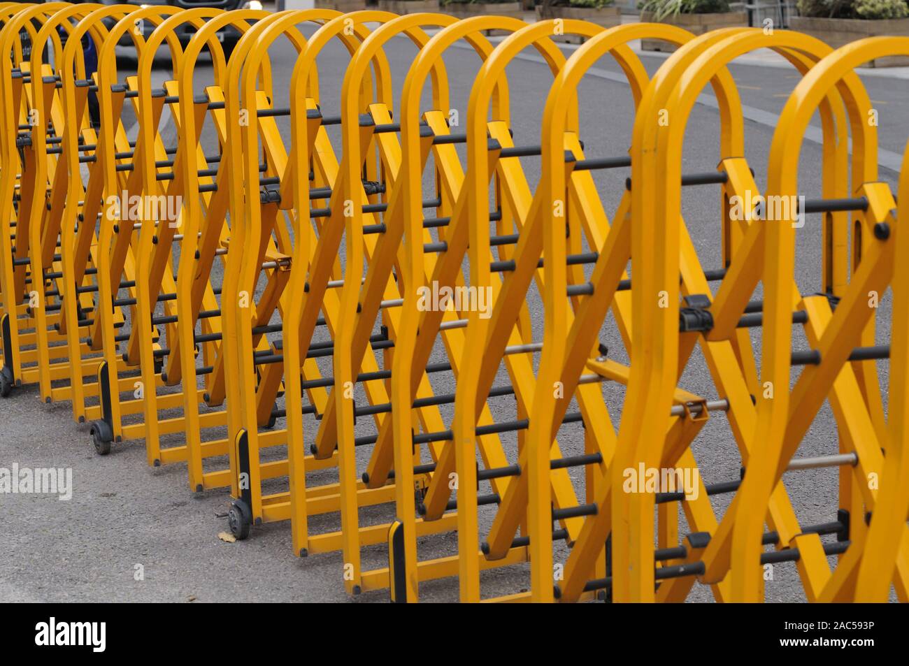 expandable temporary fencing of yellow painted metal at construction ...