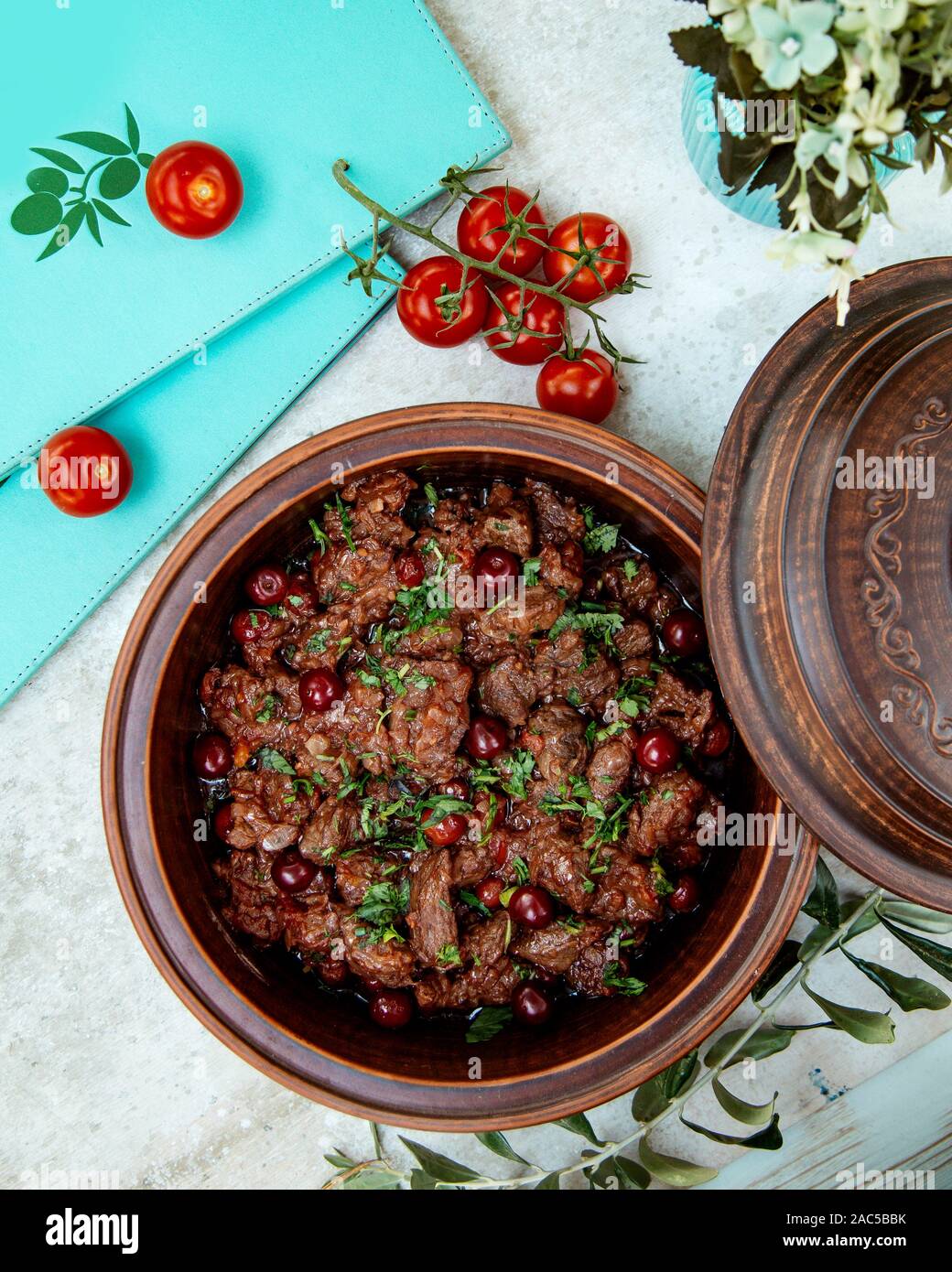 fried chopped meat with herbs and side tomatoes Stock Photo - Alamy