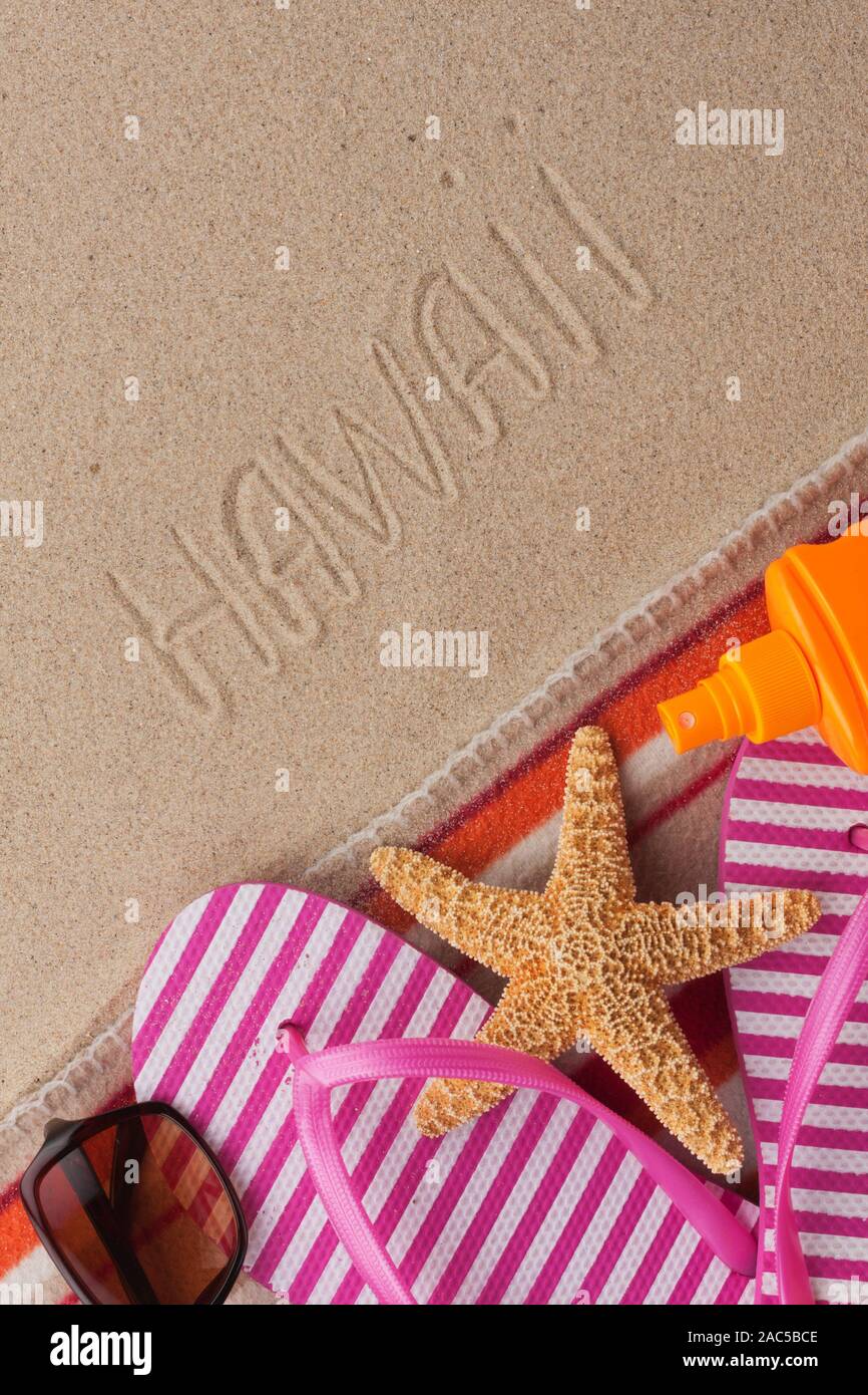 Word HAWAII written in sand with beach accessories. Travel background ...