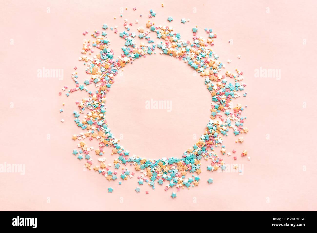 Colorful Pastel Sprinkles on pink background, top view, round copy ...