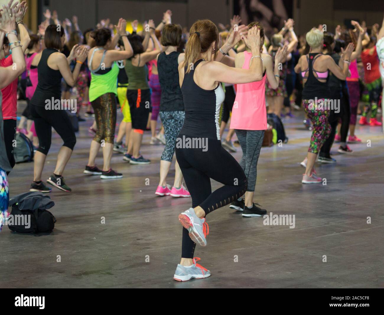 Fitness Workout in Gym: People doing Exercises in Class with Music and ...