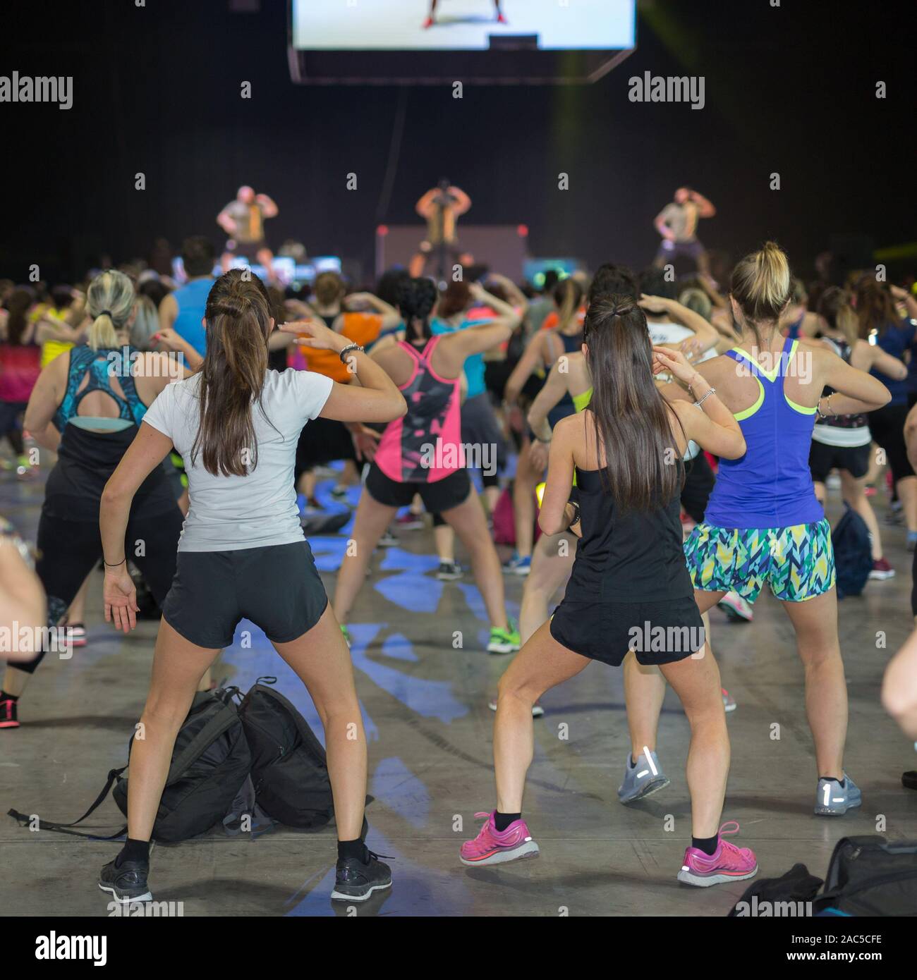 Fitness Workout in Gym: People doing Exercises in Class with Music and ...