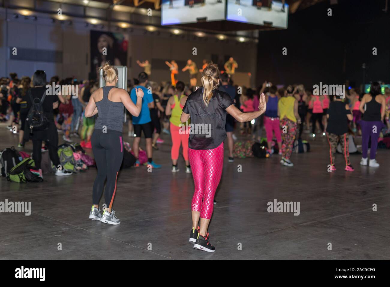 Fitness Workout in Gym: People doing Exercises in Class with Music and ...
