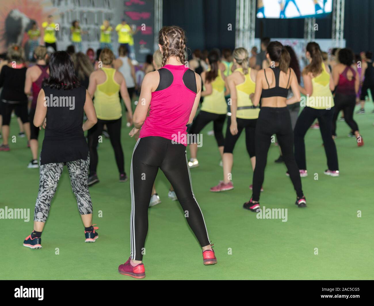 Fitness Workout in Gym: People doing Exercises in Class with Music and ...