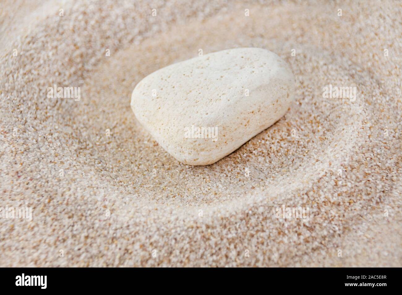 Stone close up and sand background Stock Photo - Alamy
