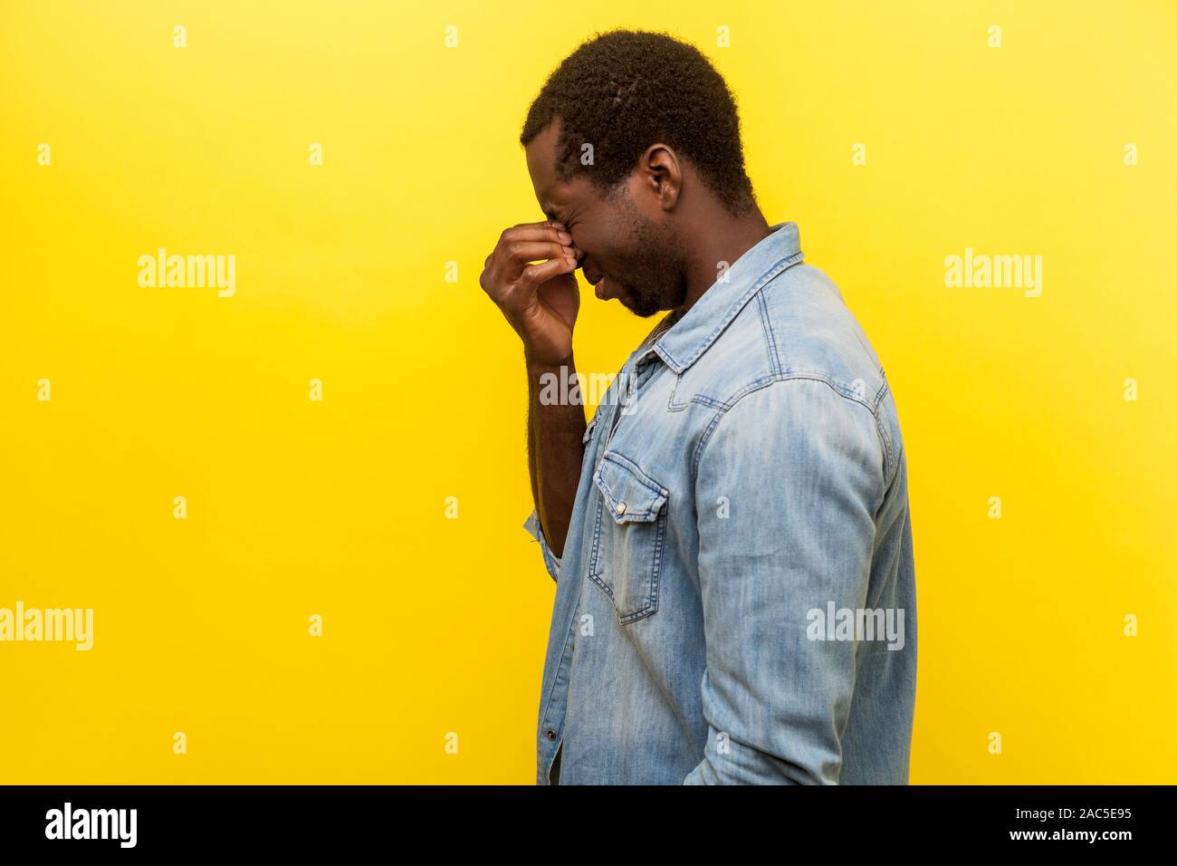 Side view portrait of distressed man with bristle in denim casual shirt ...