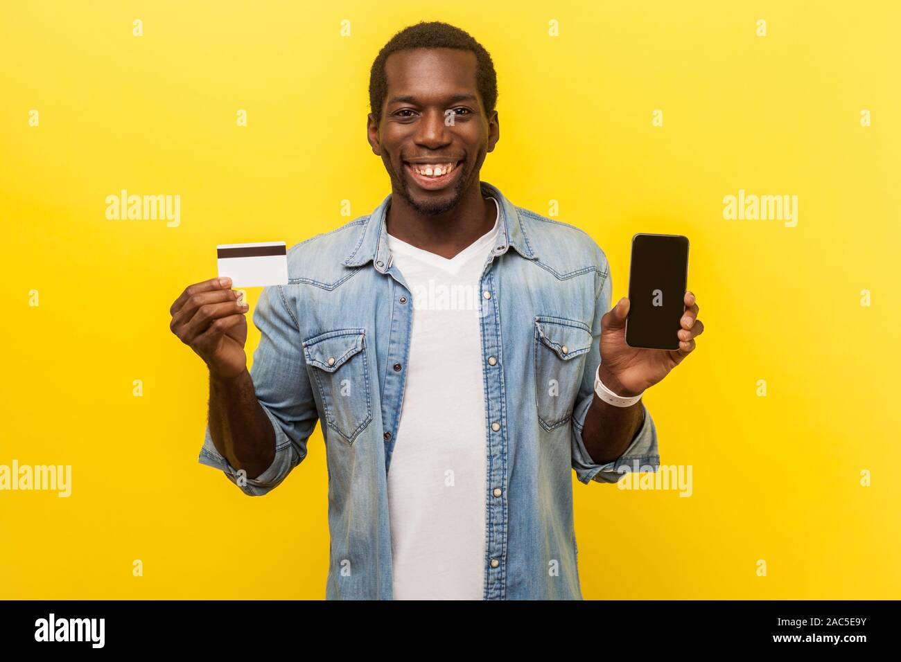 Online banking application. Portrait of happy positive man in denim ...