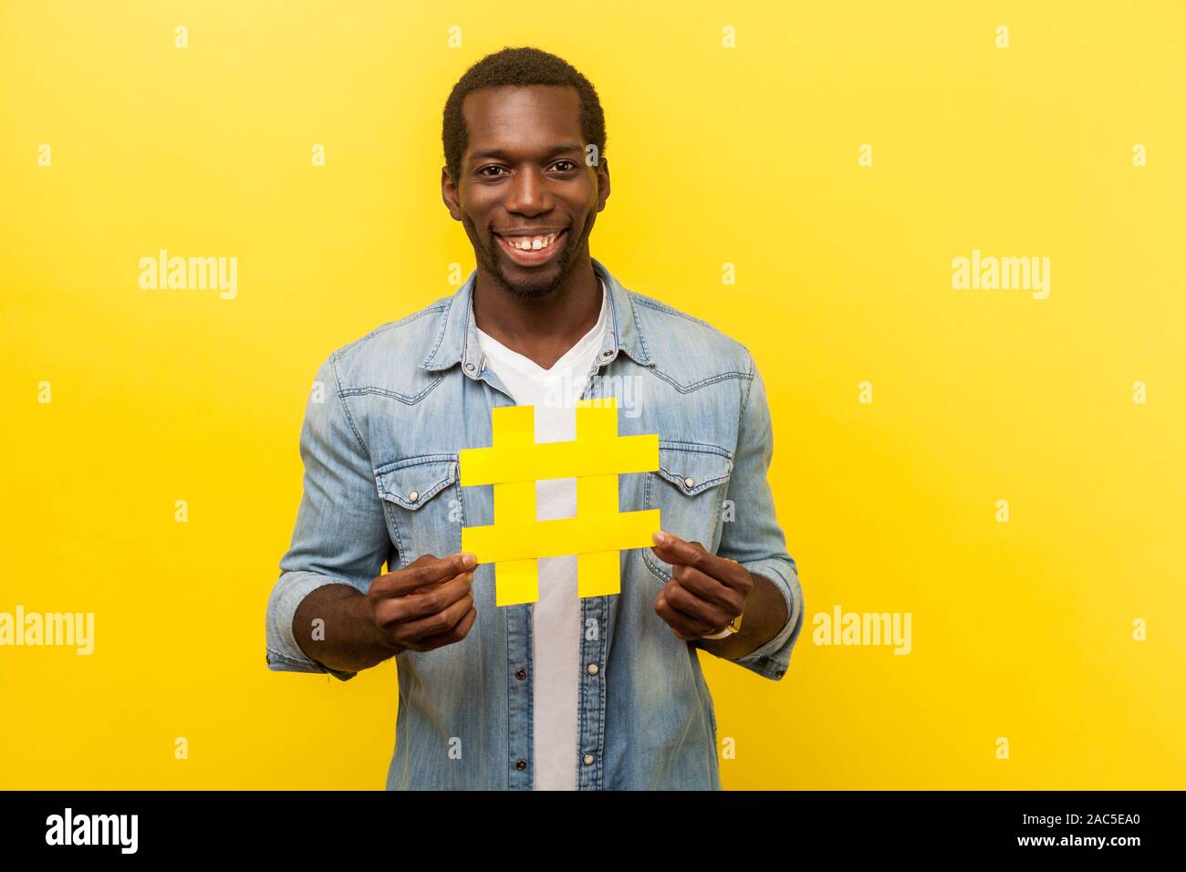 Viral hashtag. Portrait of positive man with attractive toothy smile in ...