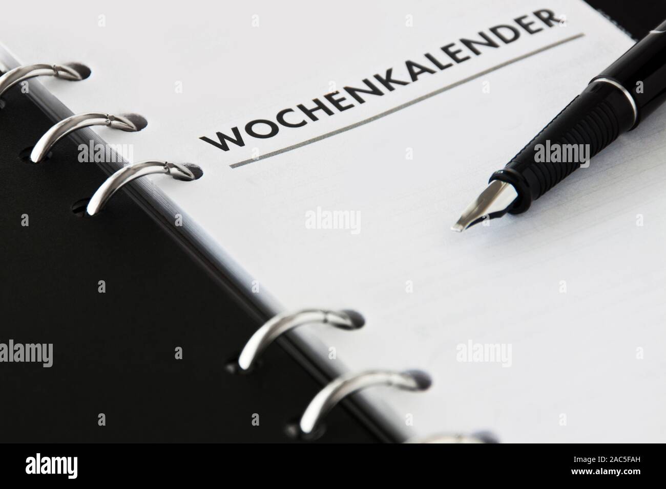 Book and pencil with German: Weekly calendar Stock Photo - Alamy