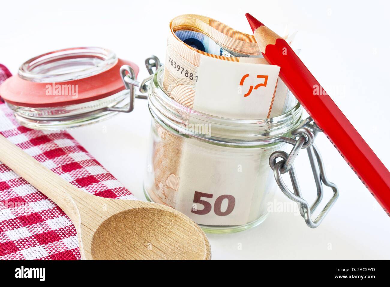 Saving money in mason jar Stock Photo - Alamy