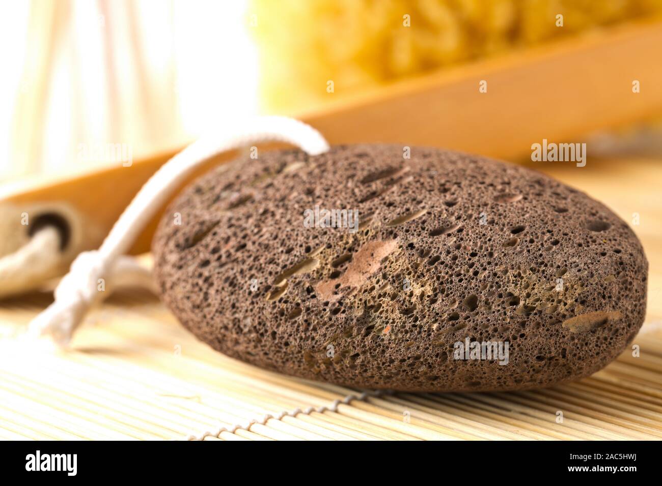 Black lava pumice stone with natural spa or bath utensils used for ...