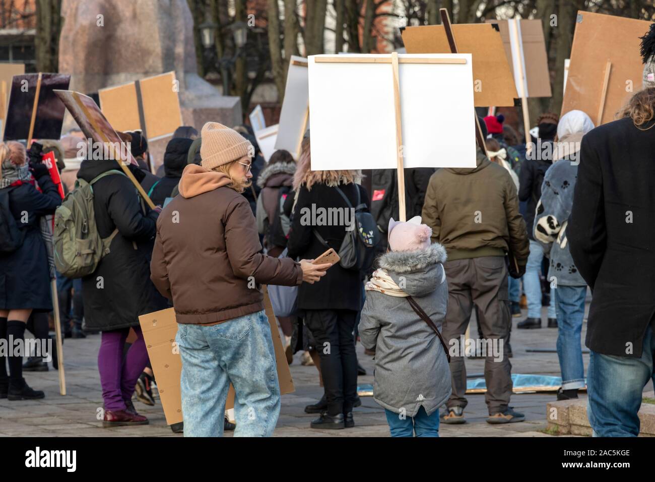 Riga, Latvia - November 30, 2019 : Back view of young mother and her ...