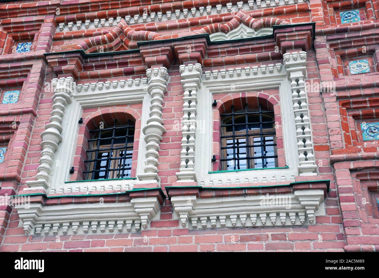 Part of the wall of the facade of a medieval building with barred ...