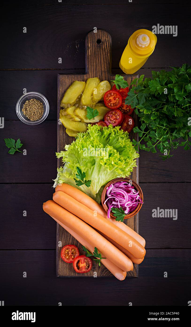 Ingredients for hot dog with sausage, pickled cucumber, tomatoes, red ...