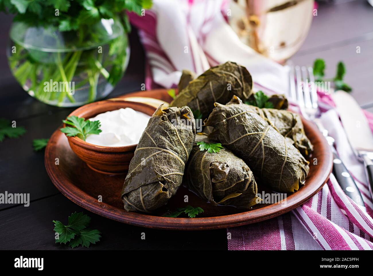 Dolma. Stuffed grape leaves with rice and meat on dark table. Middle ...