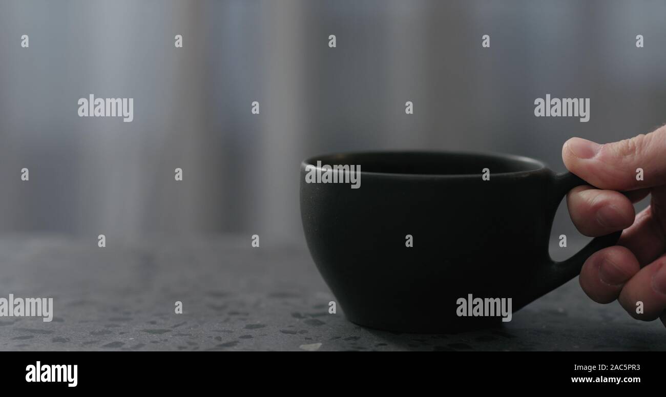 Man putting cup black coffee hi-res stock photography and images - Alamy
