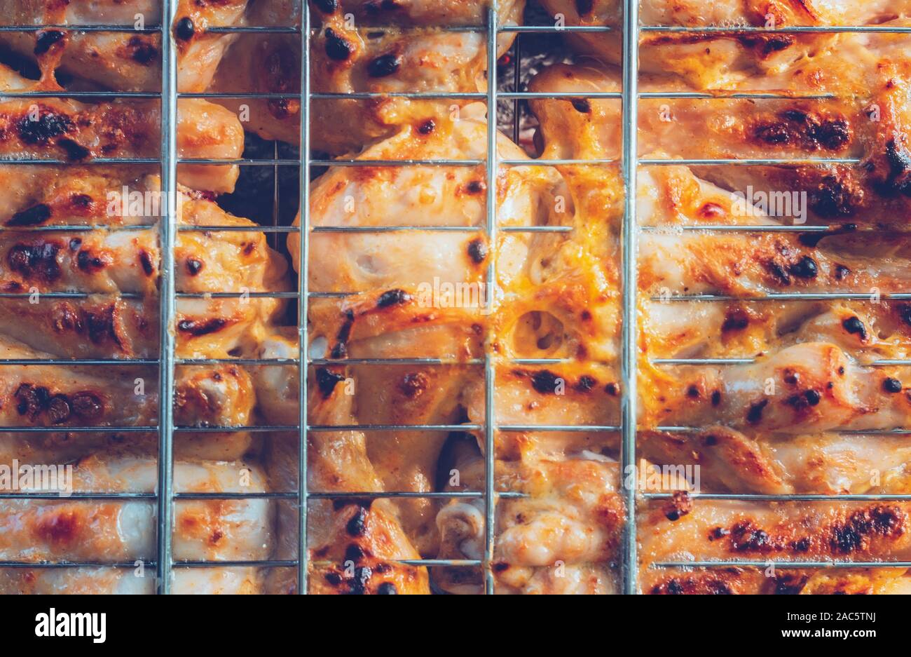 Cooking barbecue chicken on coals on grill. Selective focus. Lattice ...