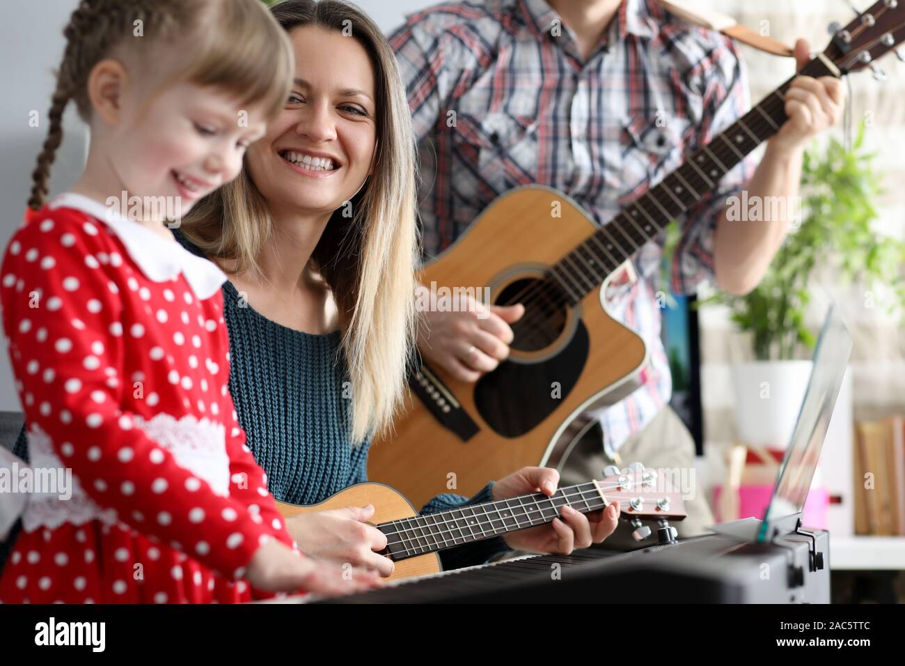 Happy family plays musical instruments on background Stock Photo - Alamy