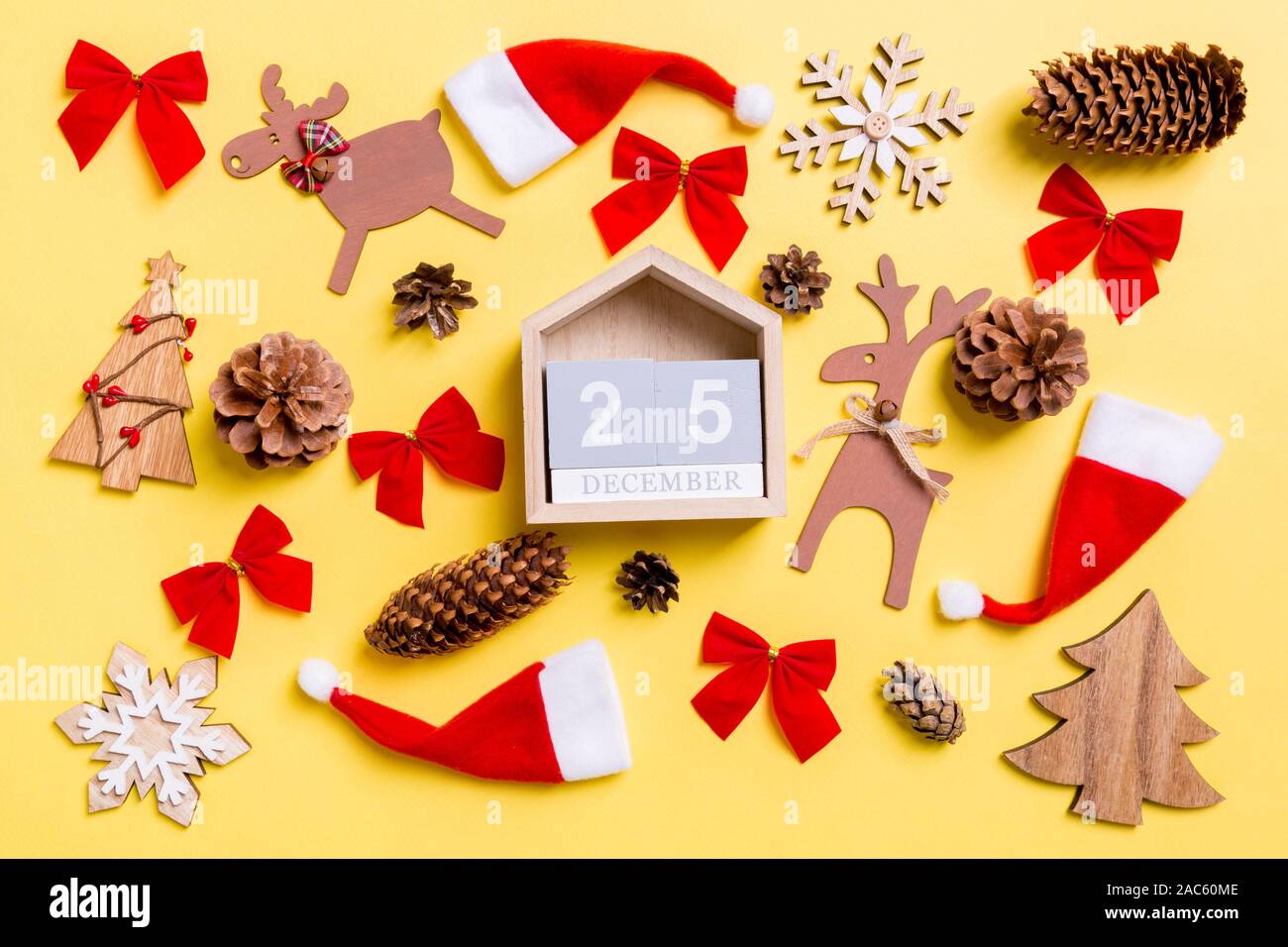 Christmas yellow background with holiday toys and decorations. Top view ...