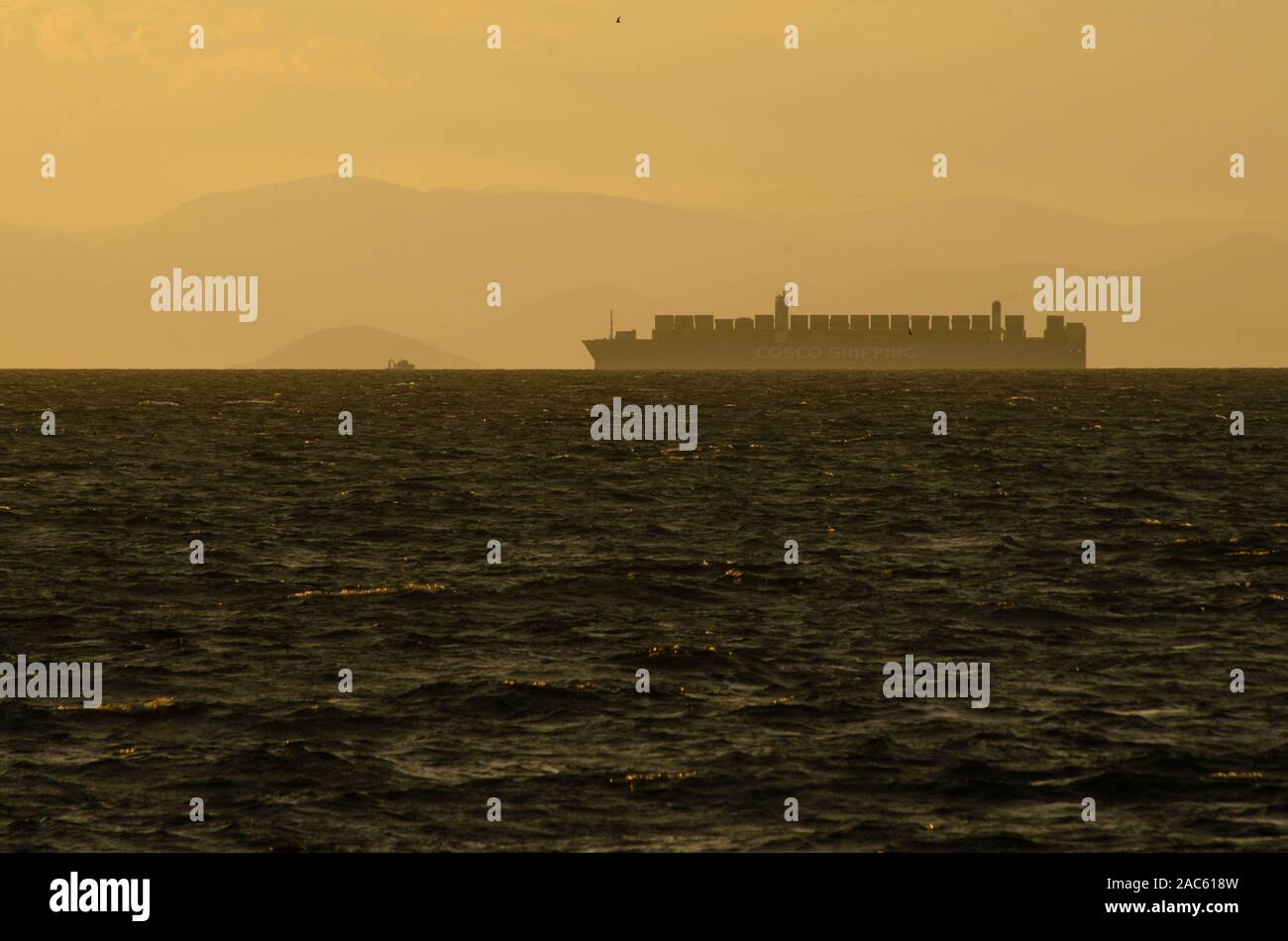 A large Cosco container ship departs from the Port of Pireaus Athens ...