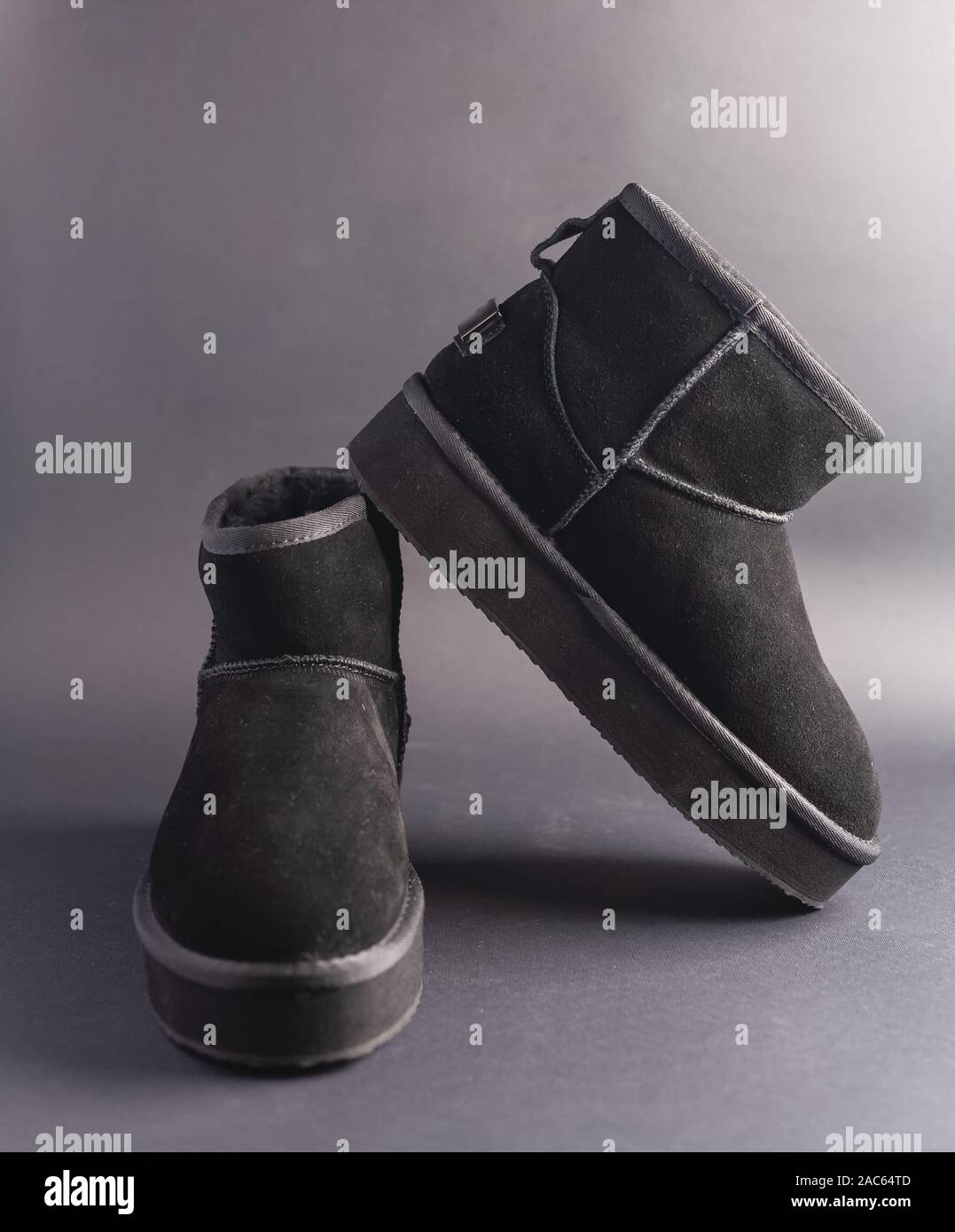 Black suede uggs. Stock photo on a black background Stock Photo - Alamy