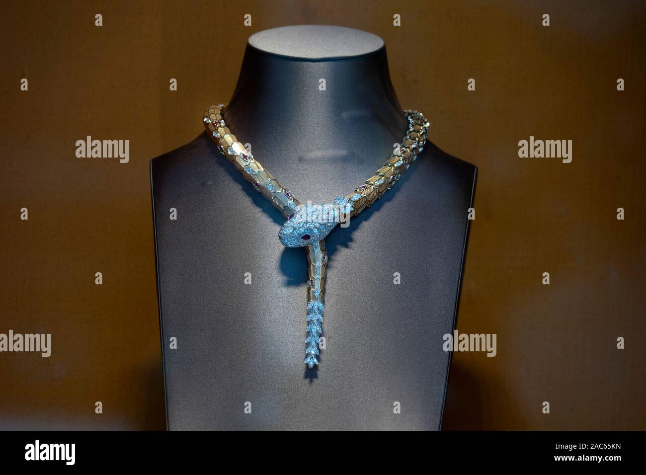 snake shape necklage ruby and diamonds on display stand Stock Photo - Alamy