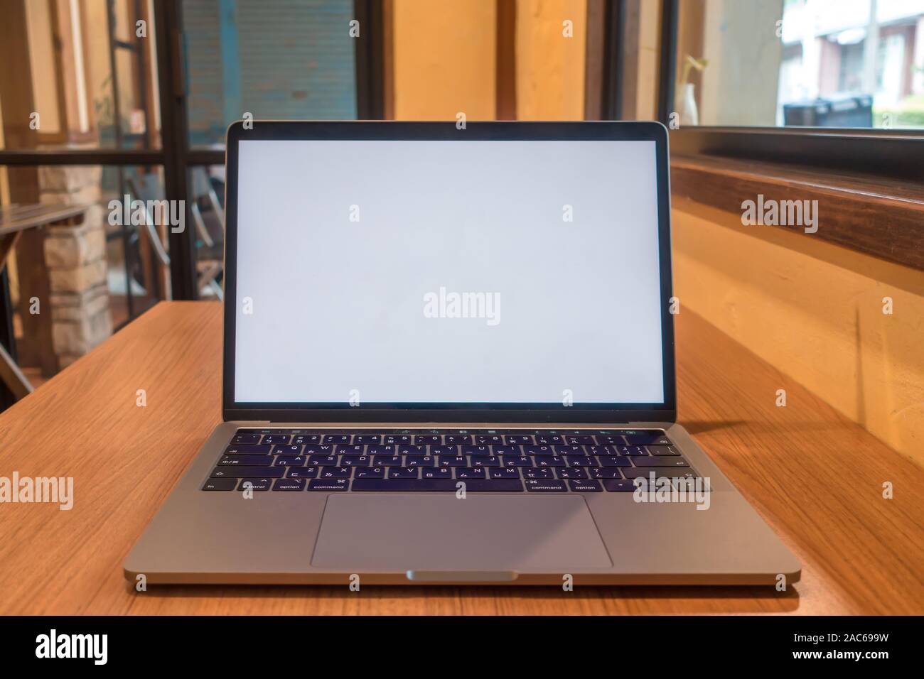 Conceptual workspace, Laptop computer with blank white screen on table ...