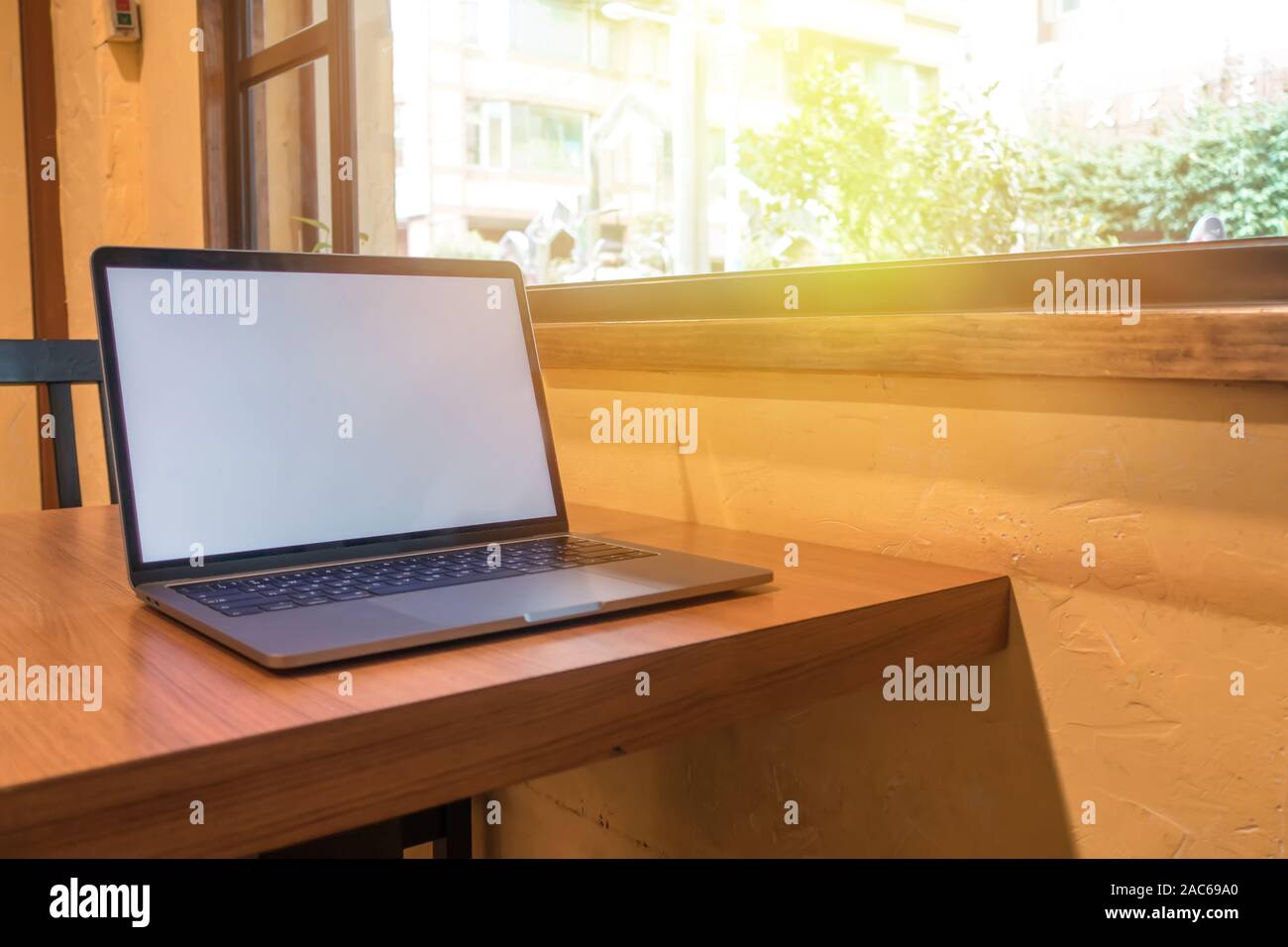 Conceptual workspace, Laptop computer with blank white screen on table ...