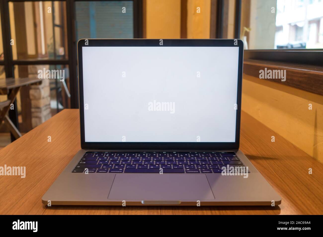 Conceptual workspace, Laptop computer with blank white screen on table ...