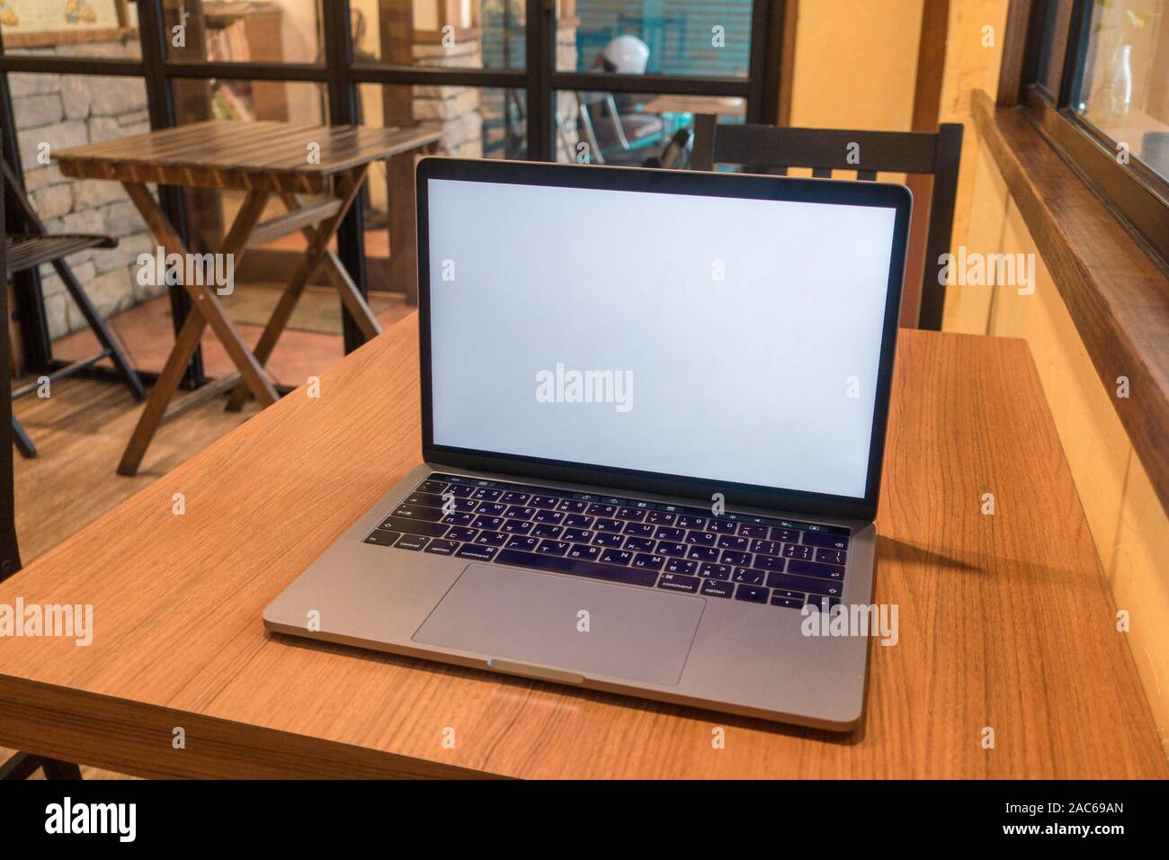 Conceptual workspace, Laptop computer with blank white screen on table ...