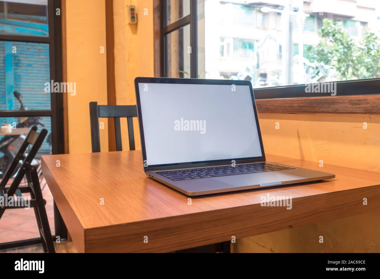 Conceptual workspace, Laptop computer with blank white screen on table ...