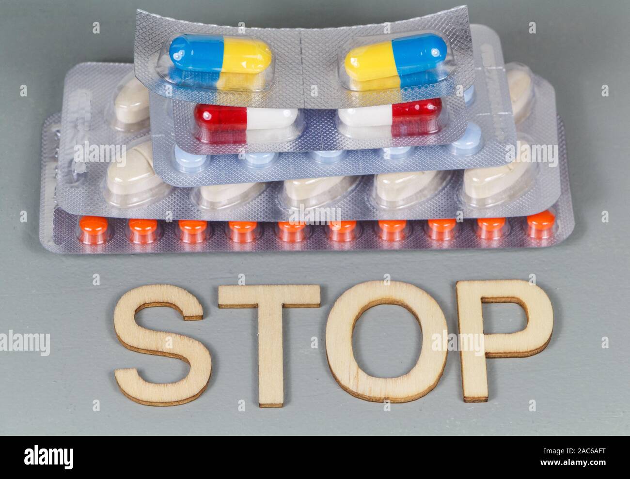 Packs of pills and stop written in wooden letters as concept for ...