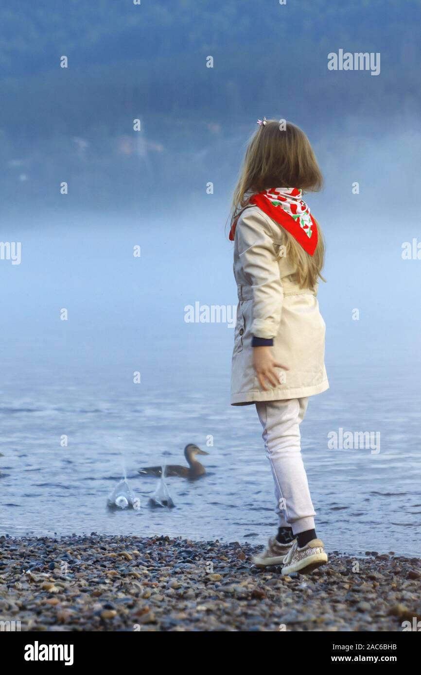Child throwing bread ducks in hi-res stock photography and images - Alamy