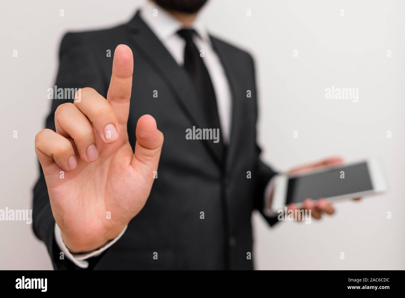 Male human wear formal work suit hold smart hi tech smartphone use one ...