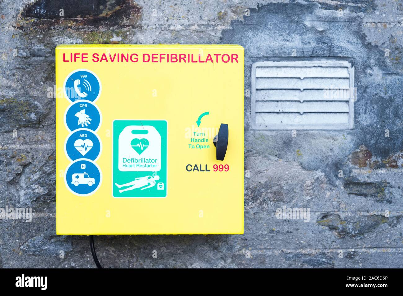 Defibrillator AED on wall for public use in a town England to save life ...