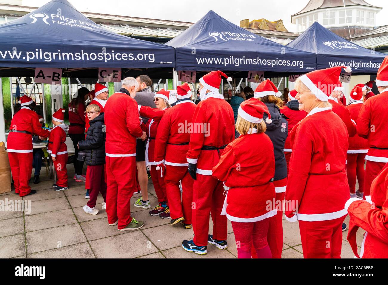Lines of people dressed up as Father Christmas, queued up waiting to ...