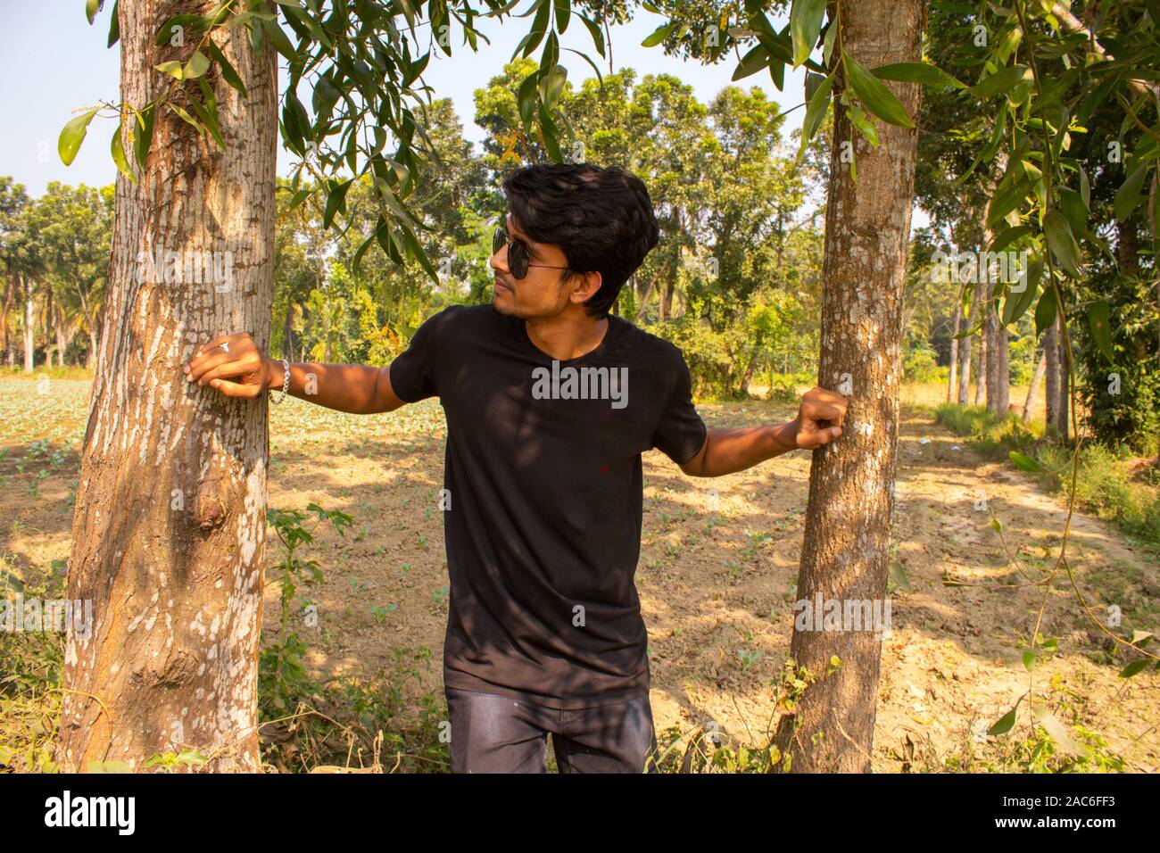 A Young boy wearing sun glass,posing with style, background is nature ...