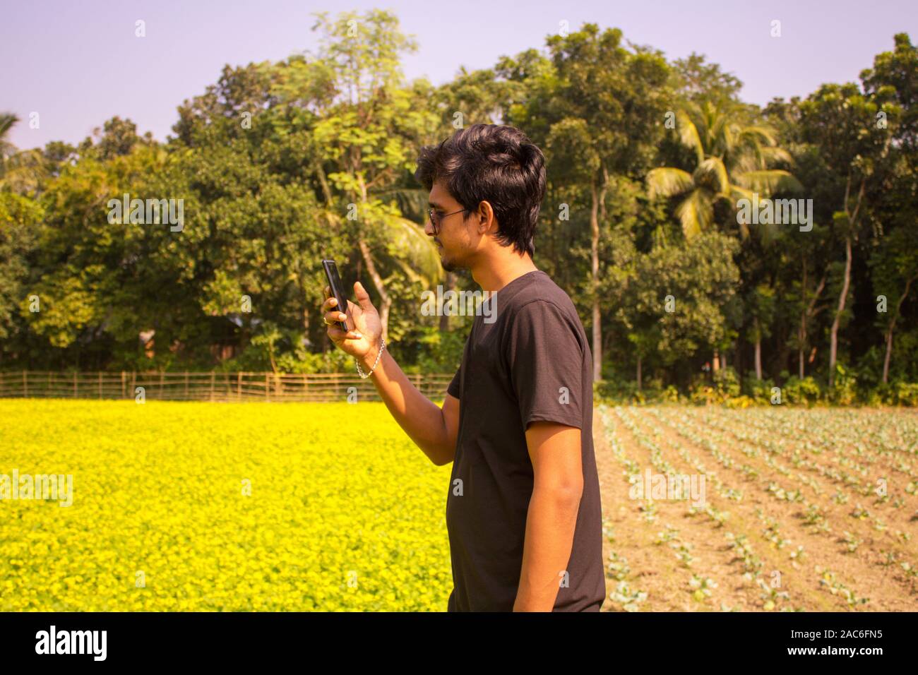 A young boy posing with his cellphone, searching mobile network in ...