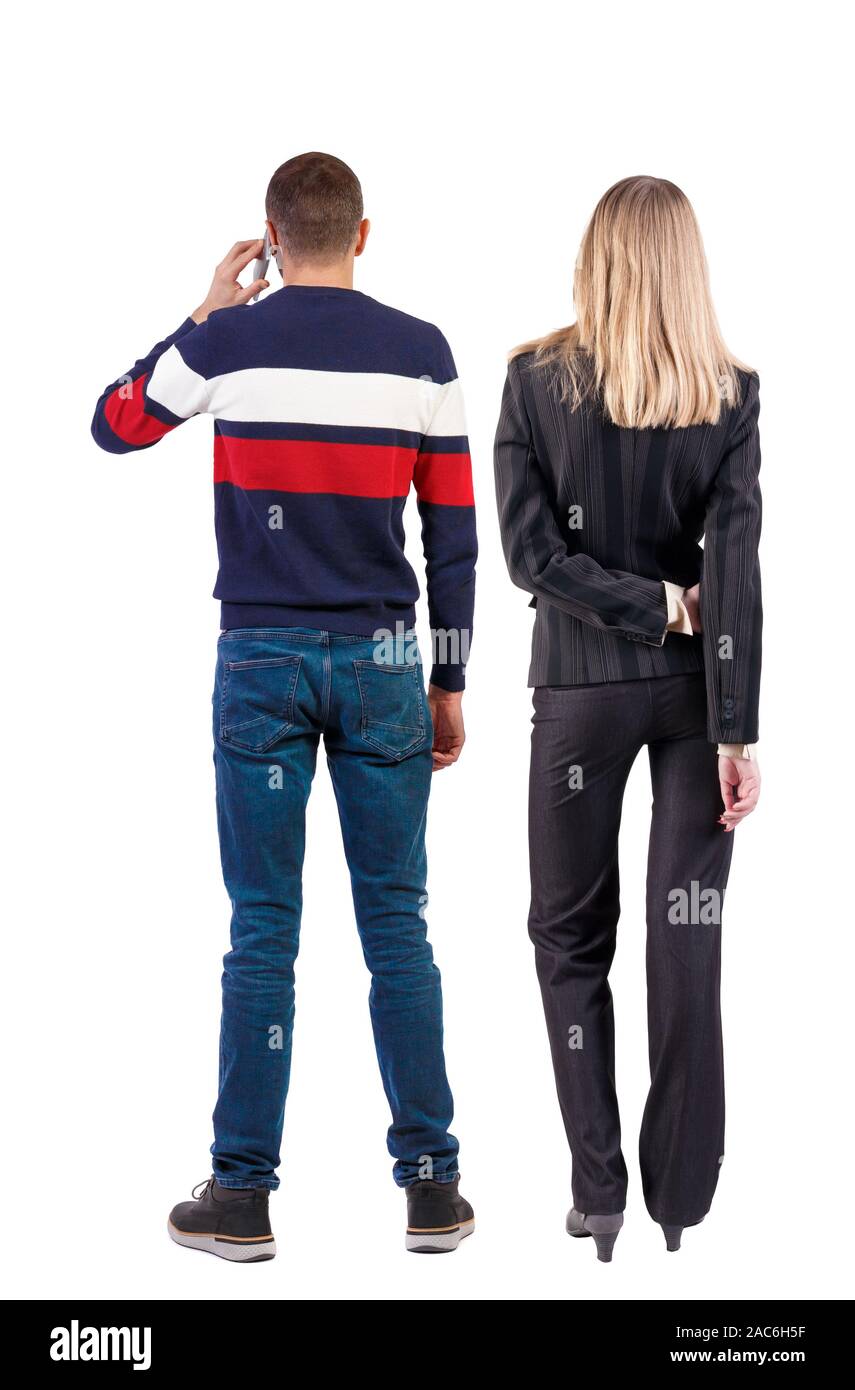 Back view of couple. beautiful friendly girl and guy together. Rear ...