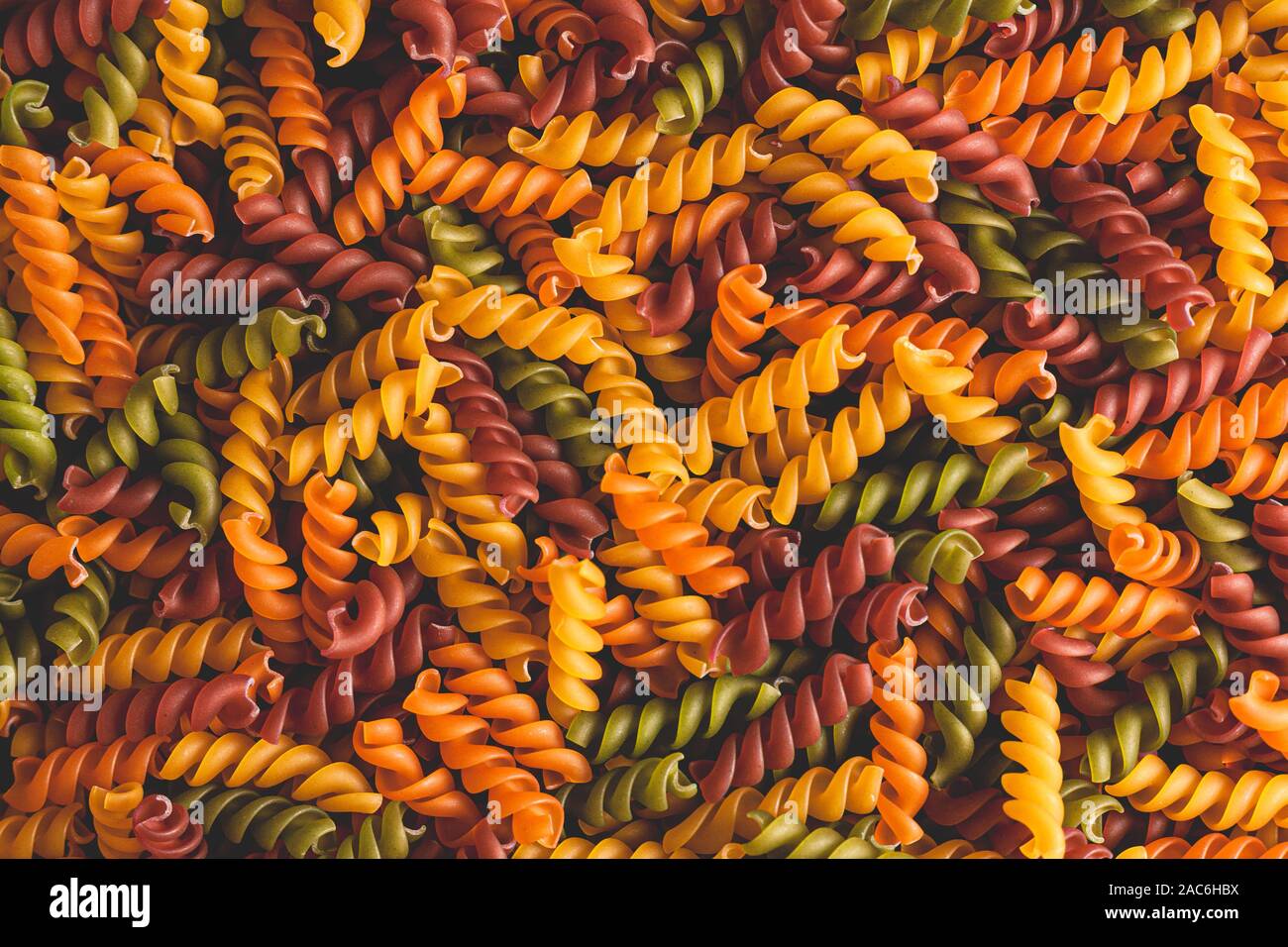 Uncooked tricolore fusilli pasta twist shapes background. Stock photo ...