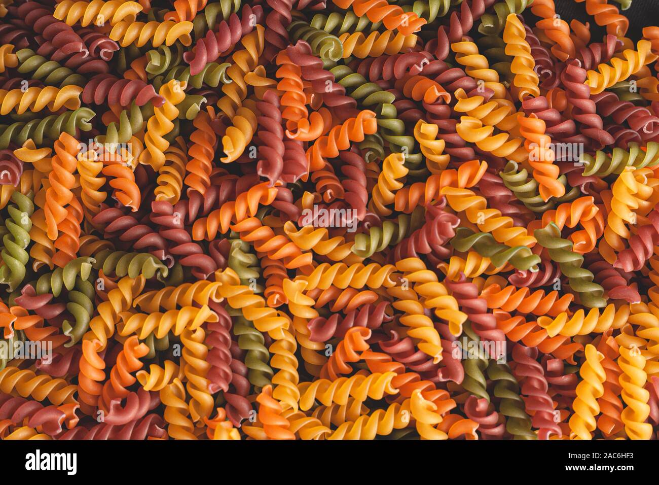 Uncooked tricolore fusilli pasta twist shapes background. Stock photo ...