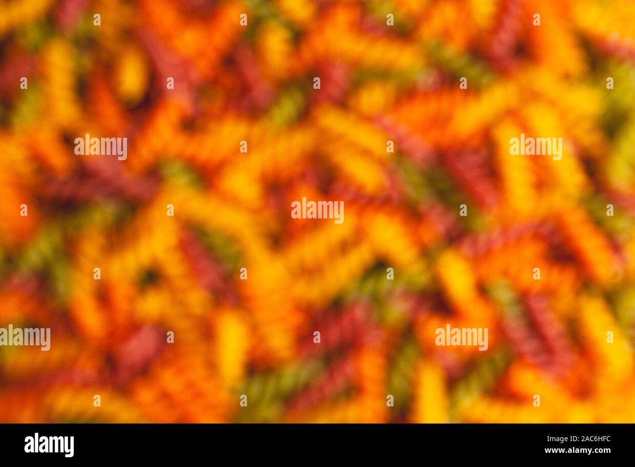 Uncooked tricolore fusilli pasta twist shapes background. Stock photo ...