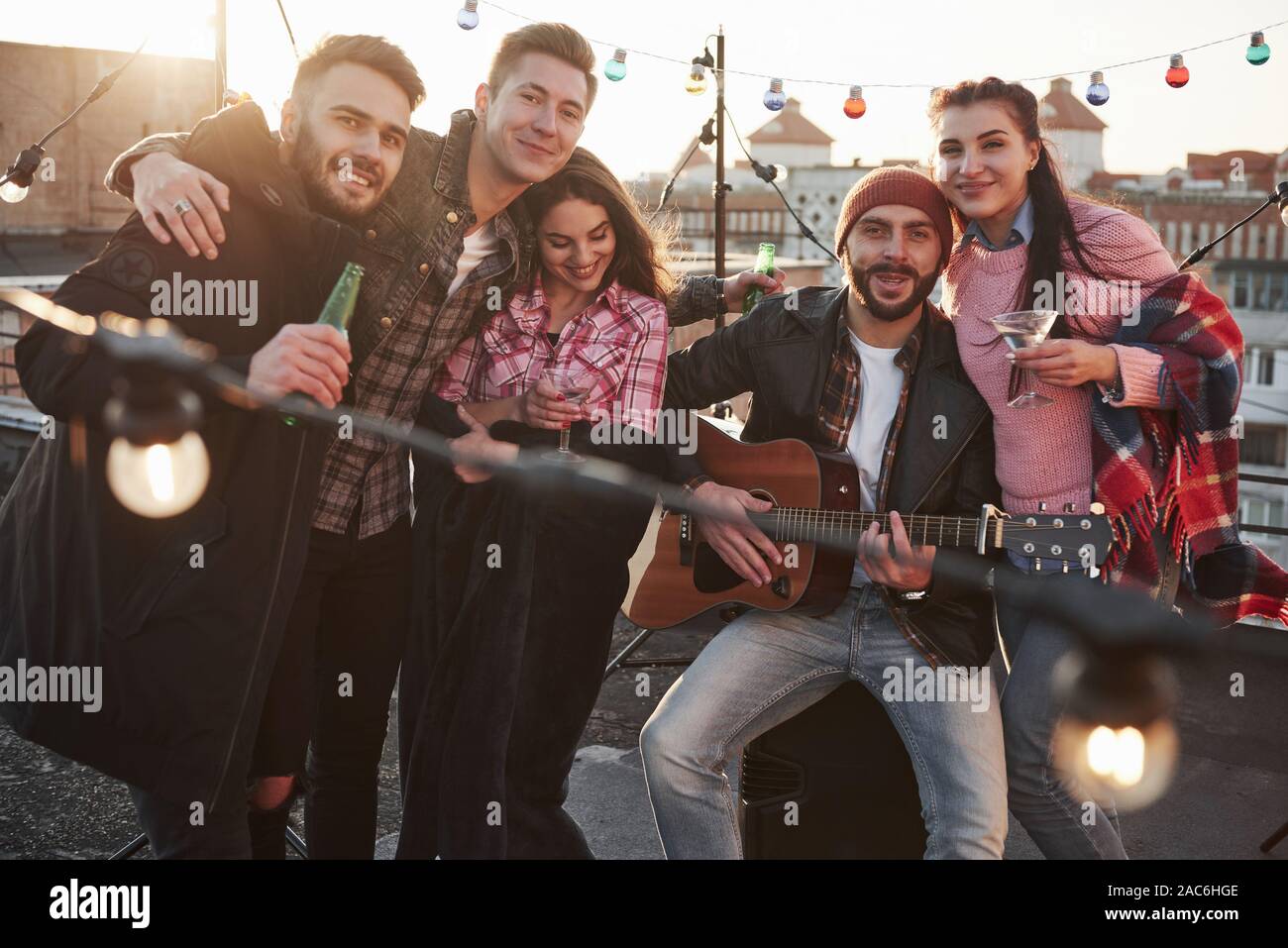 Party at the rooftop. Five good looking friends that posing for the ...