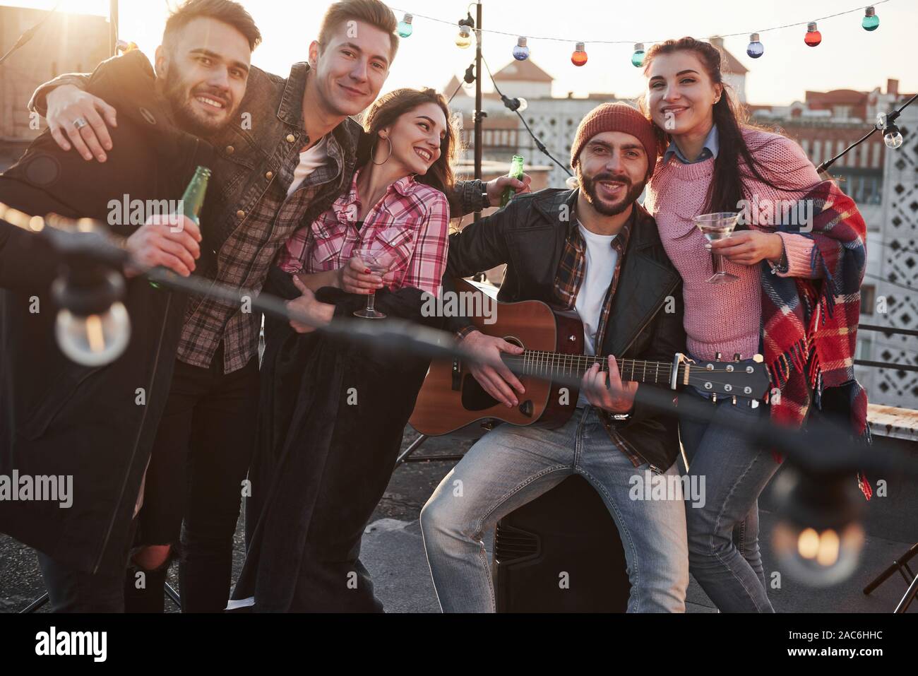 Lovely young people. Party at the rooftop. Five good looking friends ...