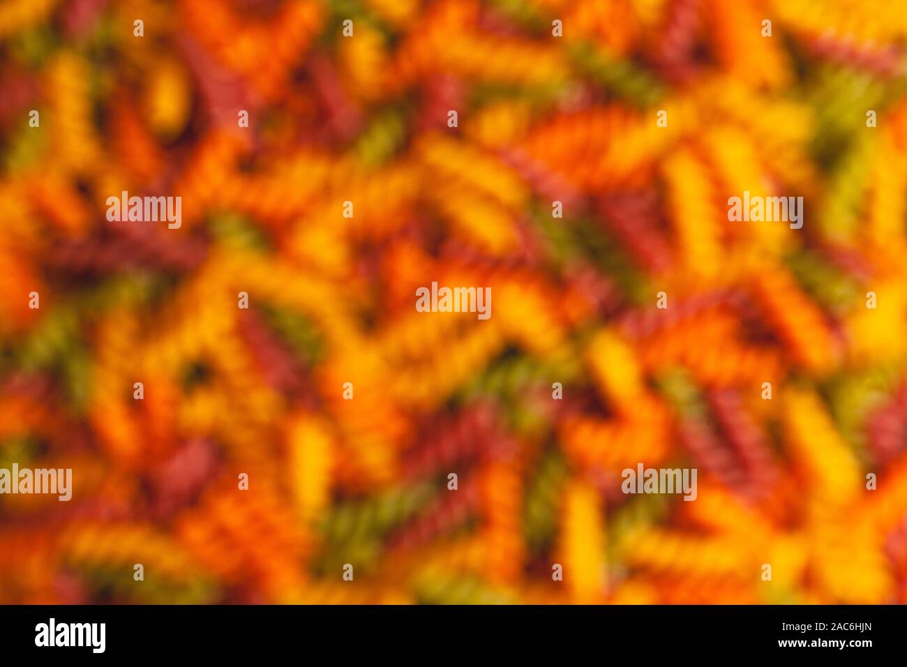 Uncooked tricolore fusilli pasta twist shapes background. Stock photo ...