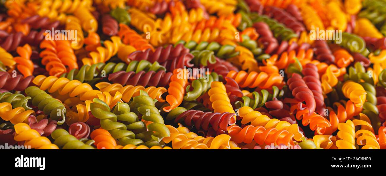 Uncooked tricolore fusilli pasta twist shapes background. Stock photo ...