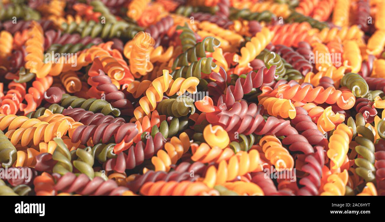 Uncooked tricolore fusilli pasta twist shapes background. Stock photo ...