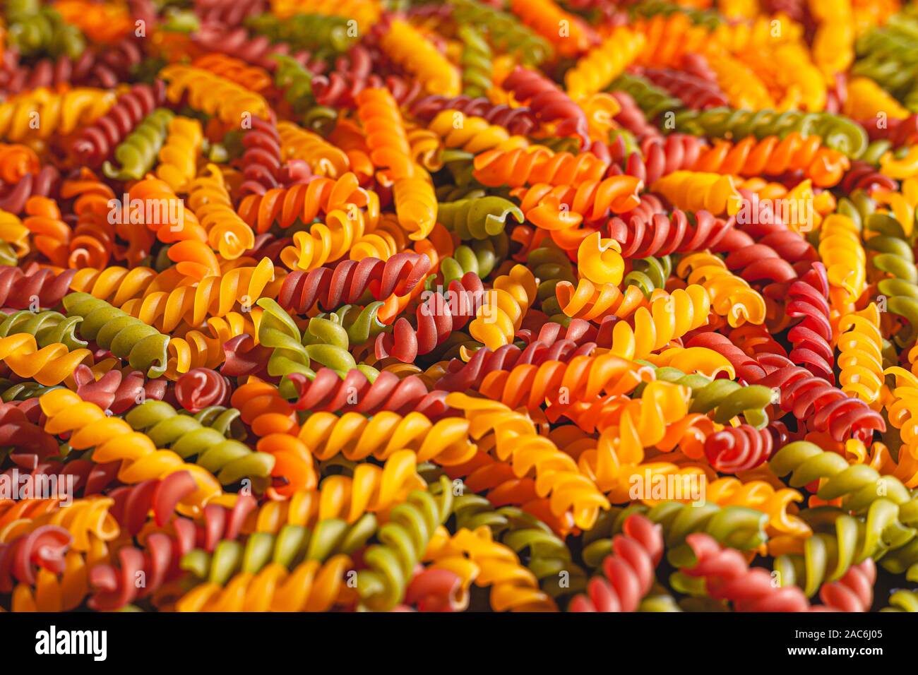 Uncooked tricolore fusilli pasta twist shapes background. Stock photo ...