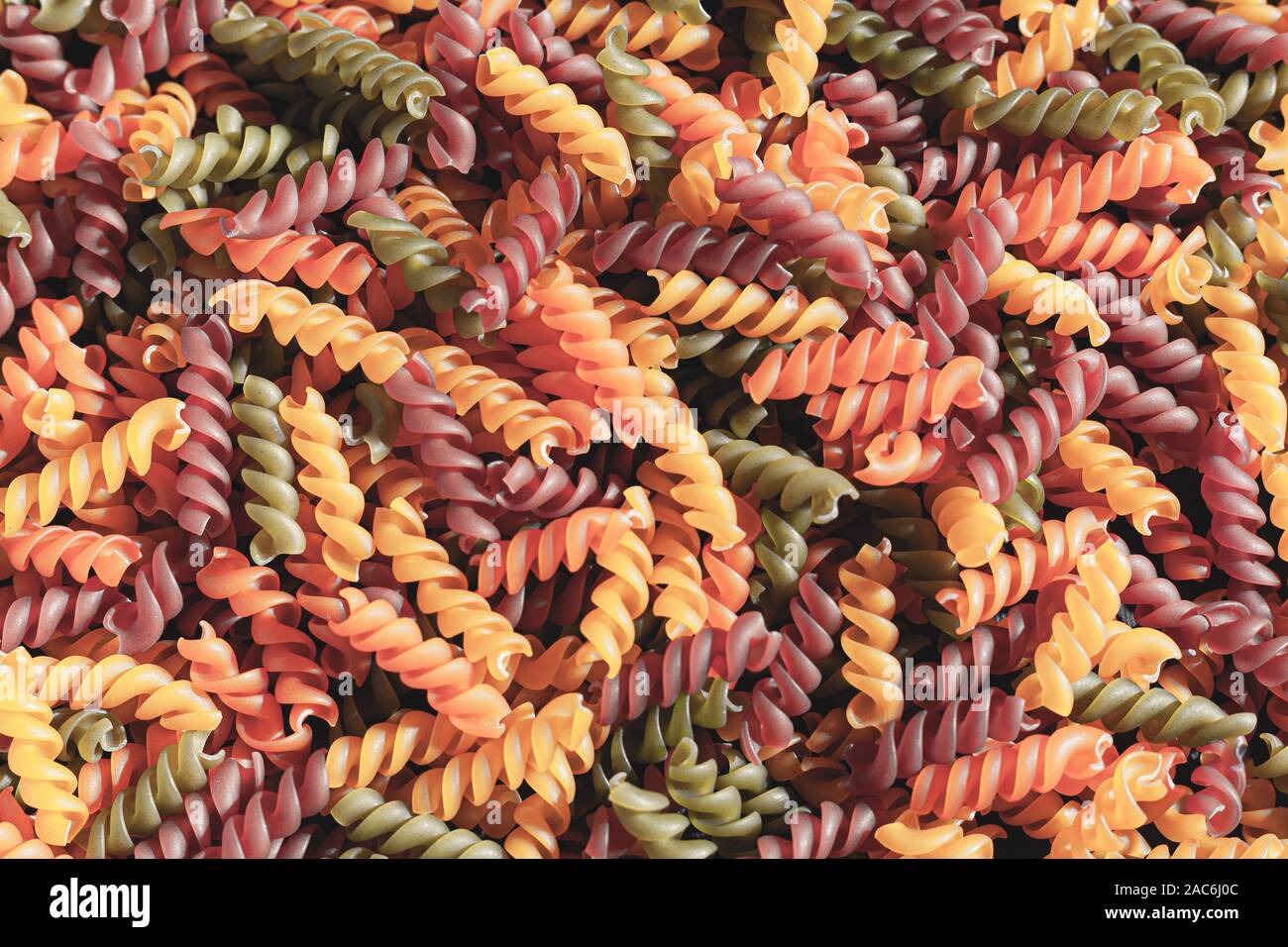 Uncooked tricolore fusilli pasta twist shapes background. Stock photo ...