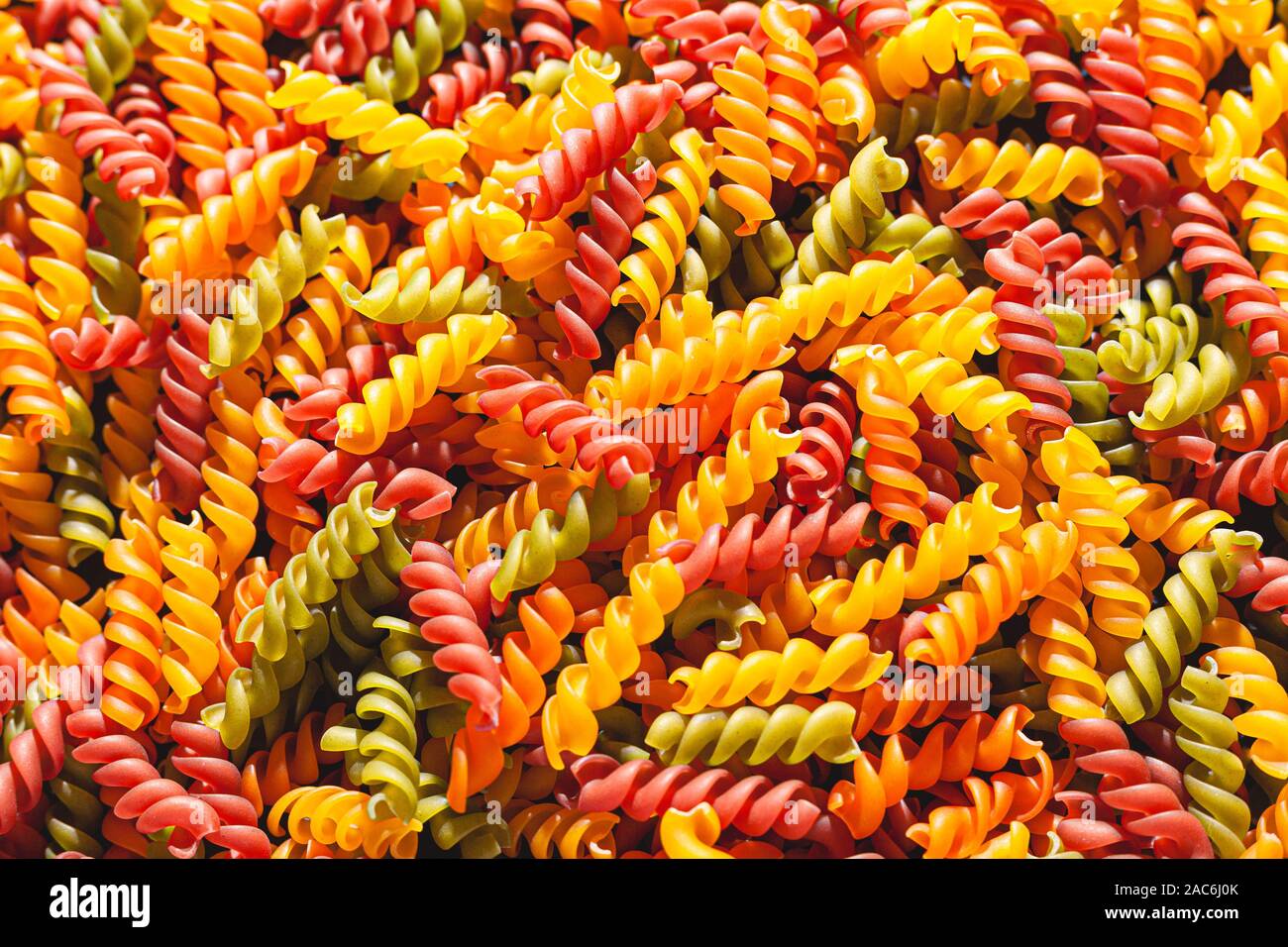 Uncooked tricolore fusilli pasta twist shapes background. Stock photo ...